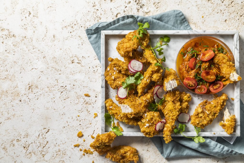 Cornflake crusted chicken strips with quick-and-easy spicy chakalaka ...